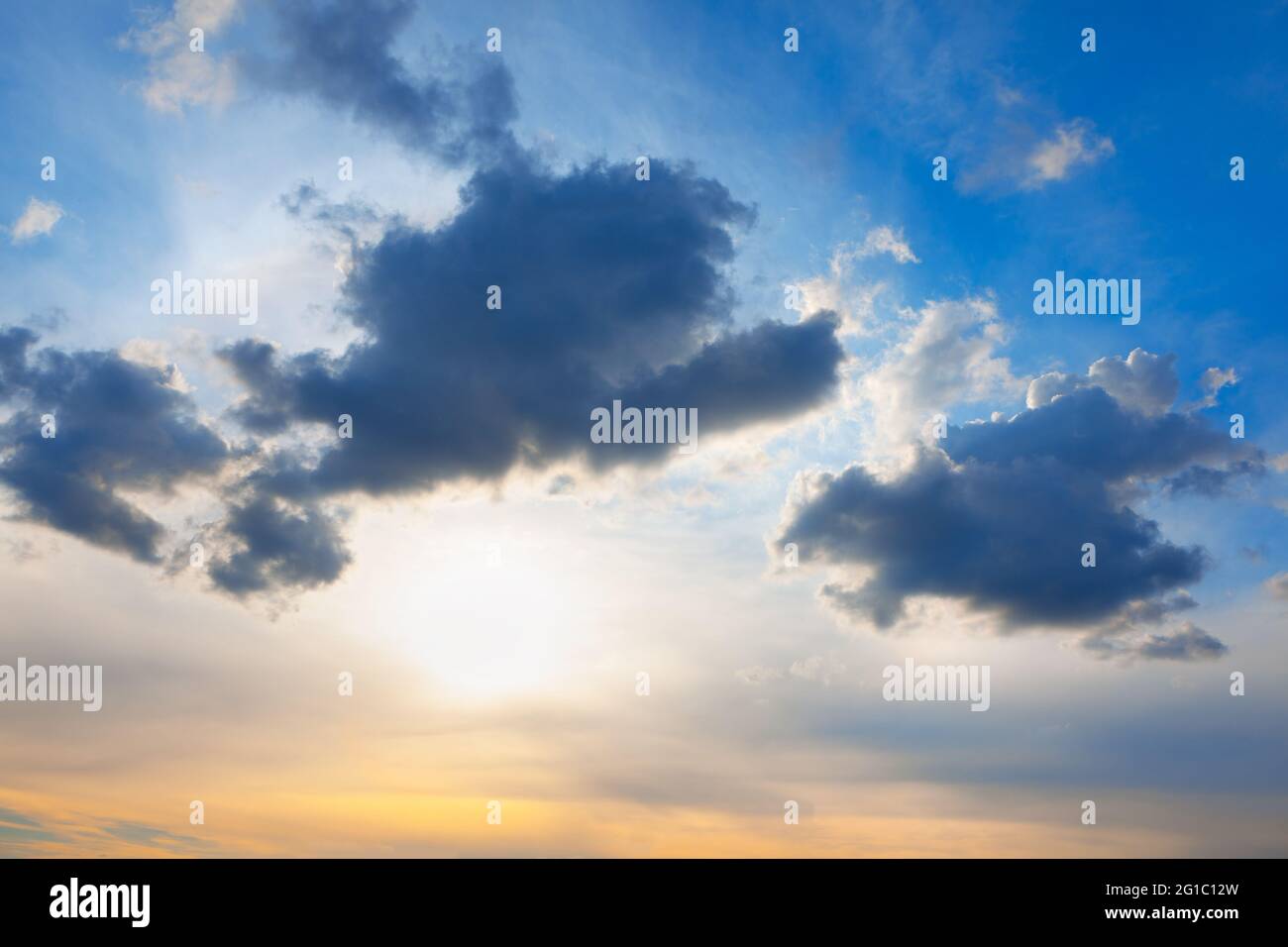 Sunset with dark clouds . Soft sunshine light Stock Photo - Alamy