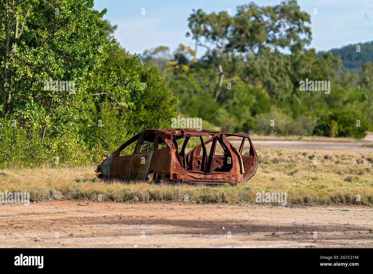 A rusting old car wreck dumped in bushland Stock Photo - Alamy