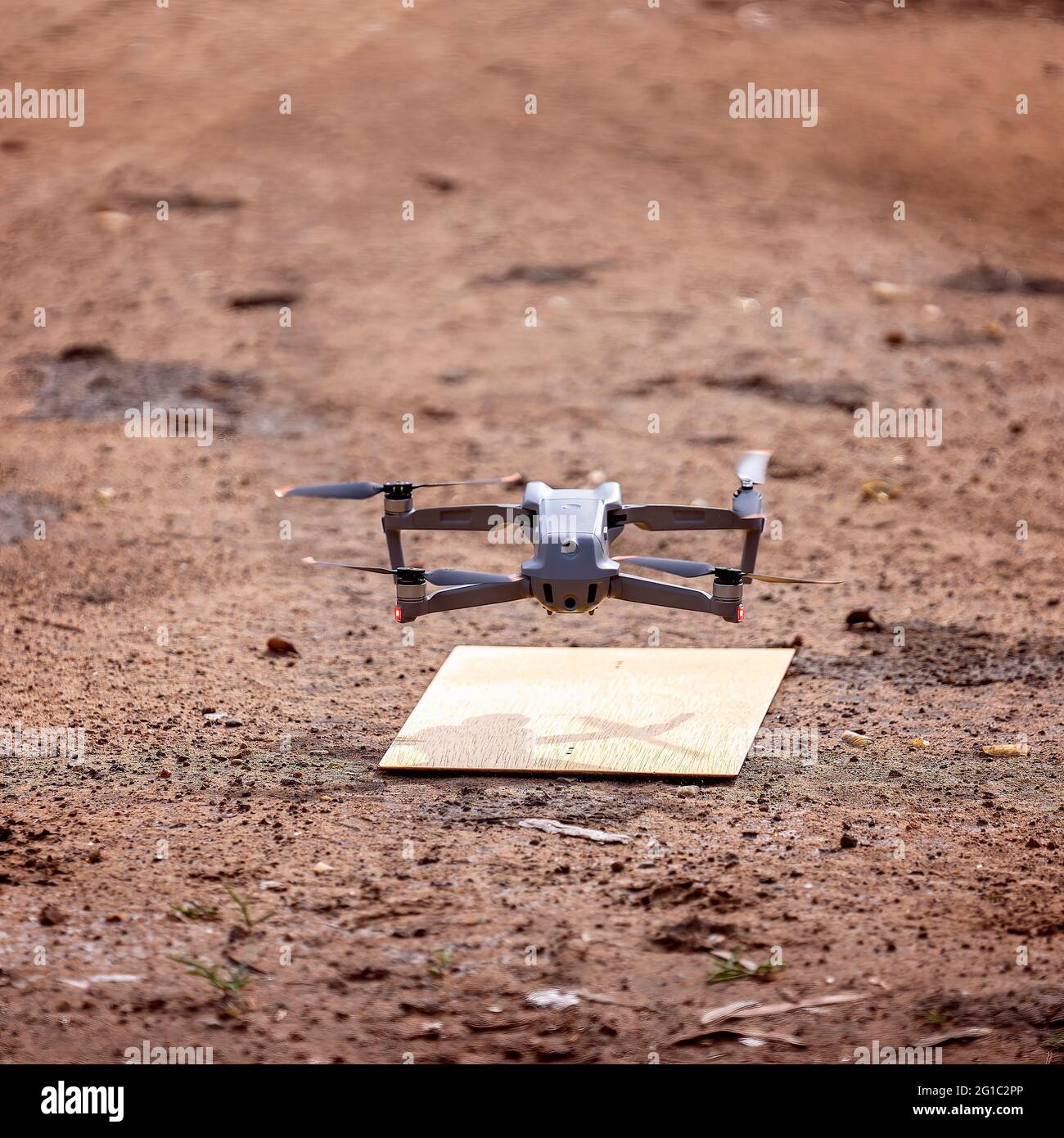 A drone taking off from its landing pad on dirt Stock Photo - Alamy