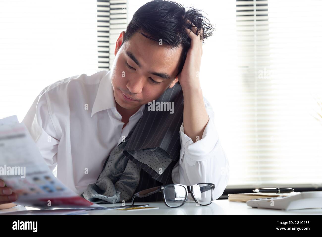 Sad confused and stressed of young Asian man holding bills letter of ...