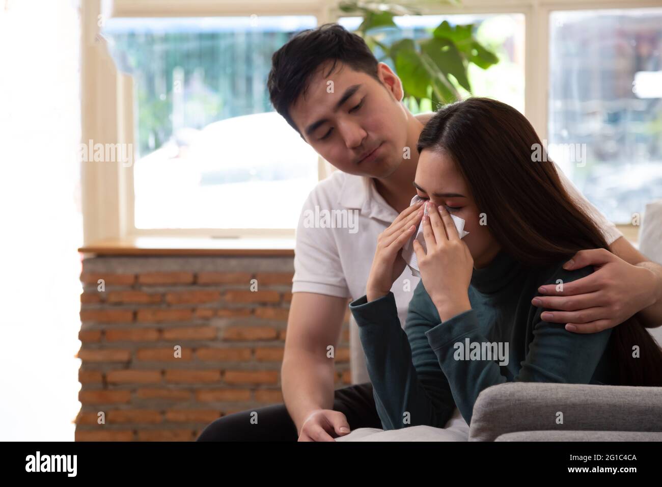 Sad and tired woman and crying with boyfriend on the sofa. Depression ...