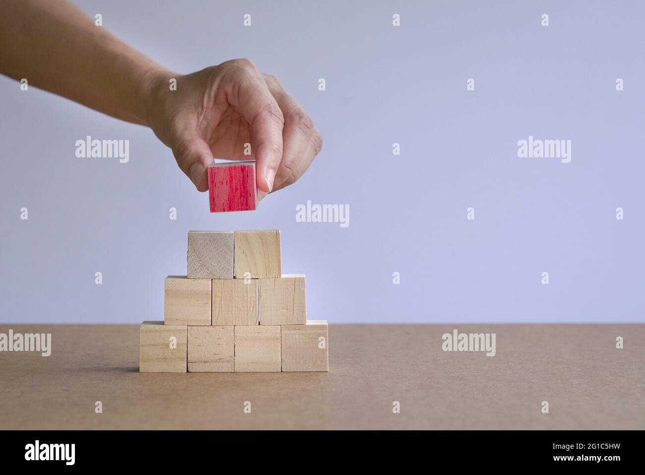 Hand top on pyramid hi-res stock photography and images - Alamy