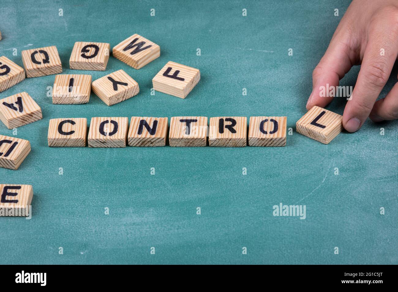 CONTROL. Wooden alphabet letters on a green blackboard background Stock ...