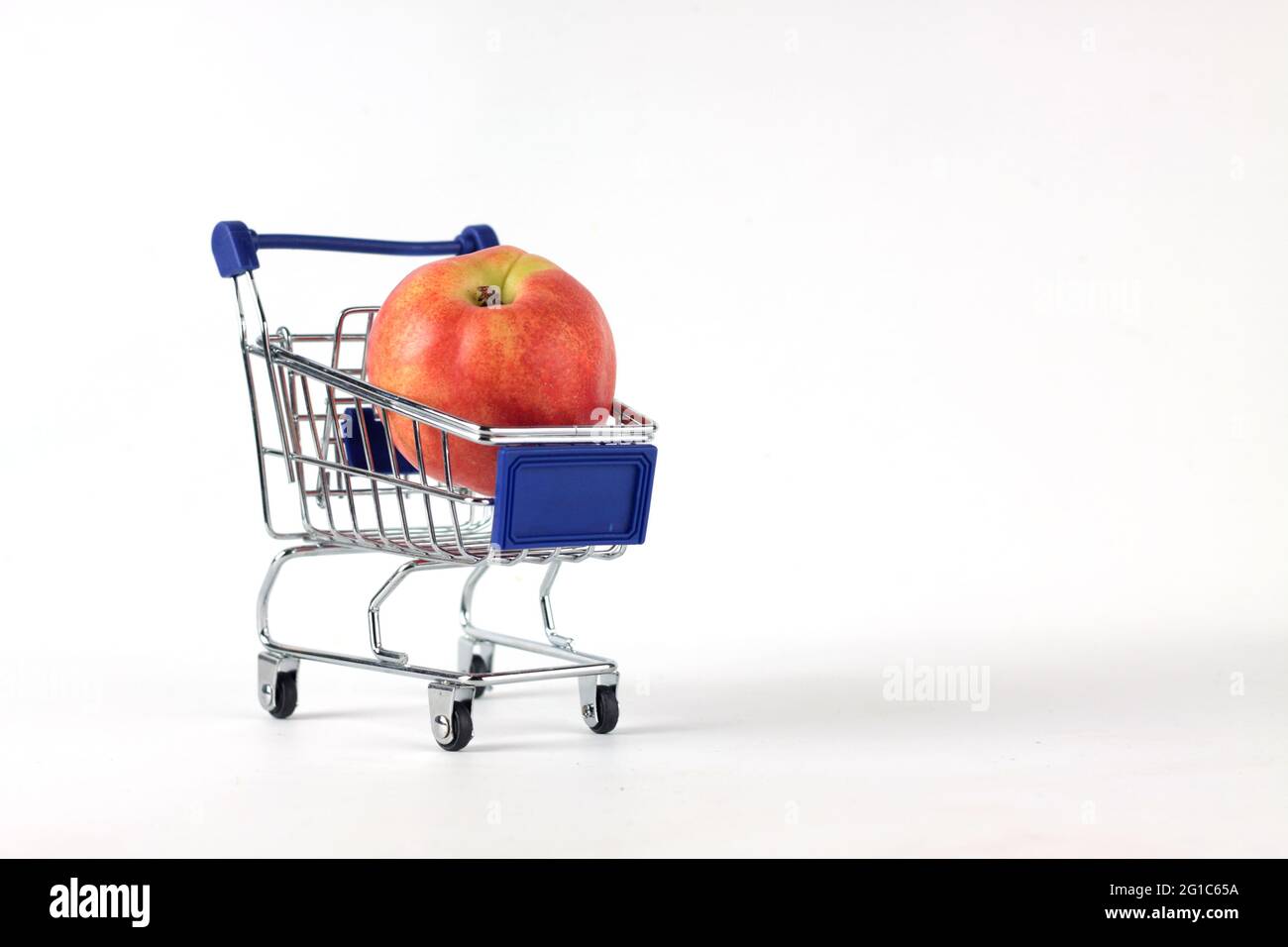 Healthy eating concept. Juicy nectarine in a shopping cart isolated on ...