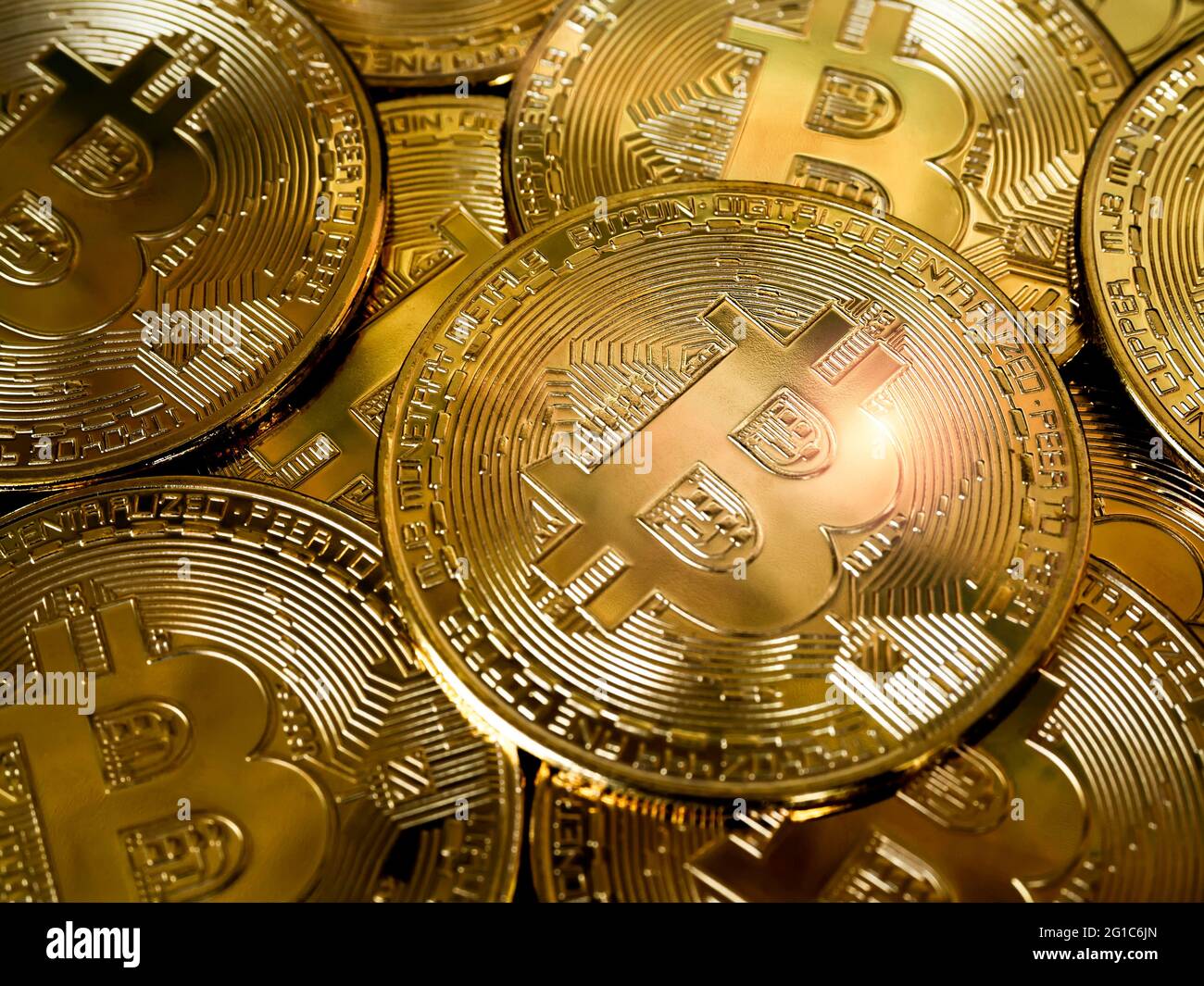 Bitcoin technology background. Close up pile of golden bitcoin on dark ...