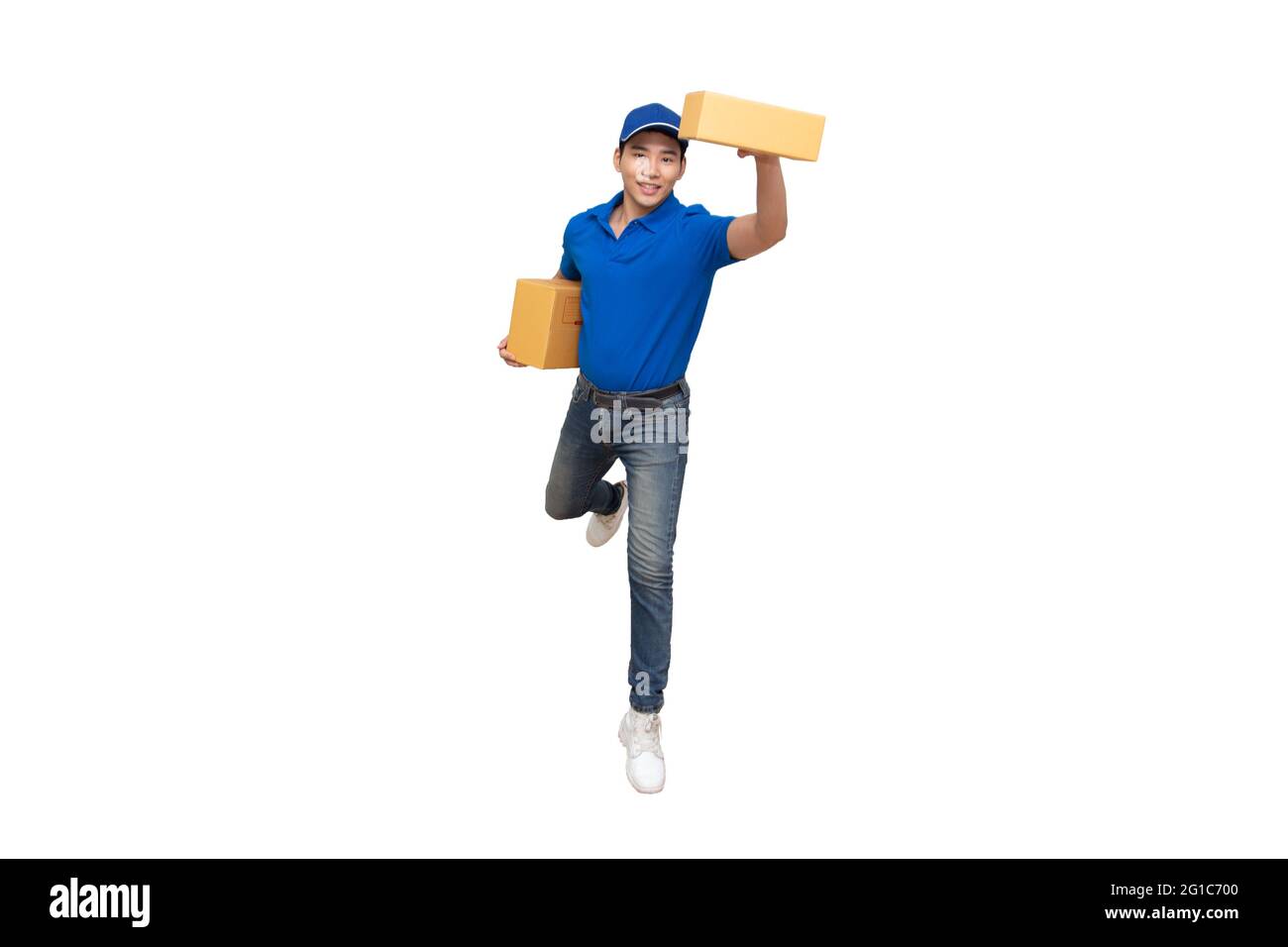 Energetic young Asian delivery man jumping and holding boxes isolated ...
