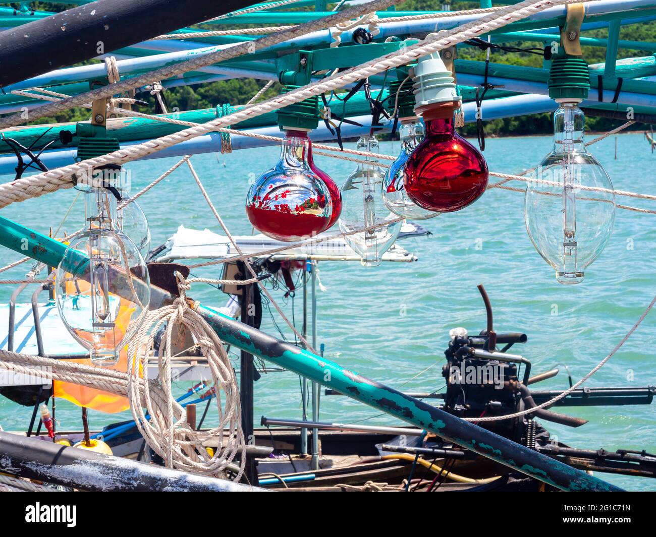 Light lamps and many messy ropes on wooden local fisherman boat at the ...