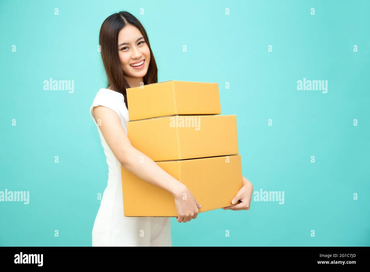 Happy Asian woman holding package parcel box, Delivery courier and shipment service concept ...