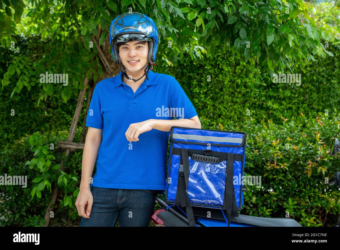 Young Asian man with delivery box, Motorcycle delivering food express ...