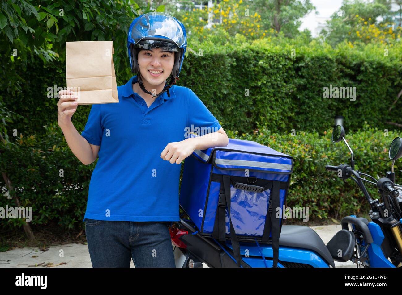 Young Asian man with delivery box, Motorcycle delivering food express ...