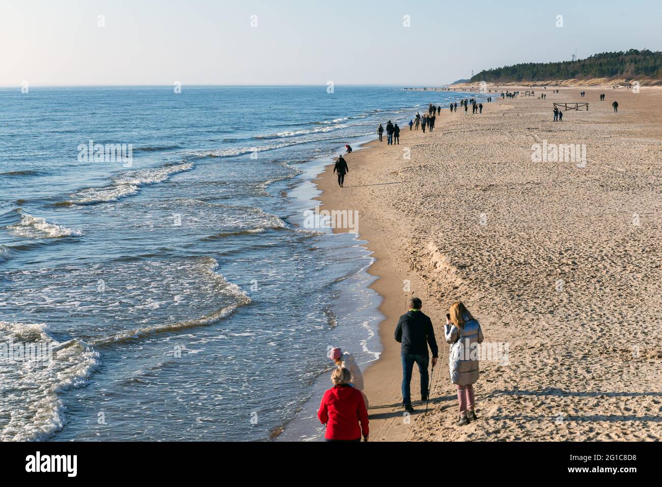 Several of people walking on the beach in spring.People walking on the ...