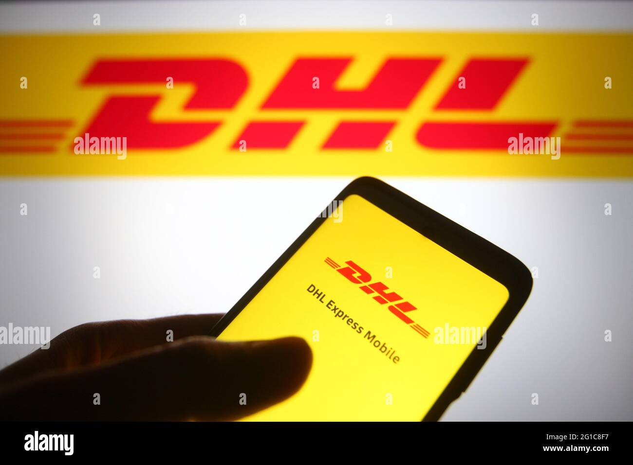 In this photo illustration, the DHL Express Mobile logo is seen on a ...