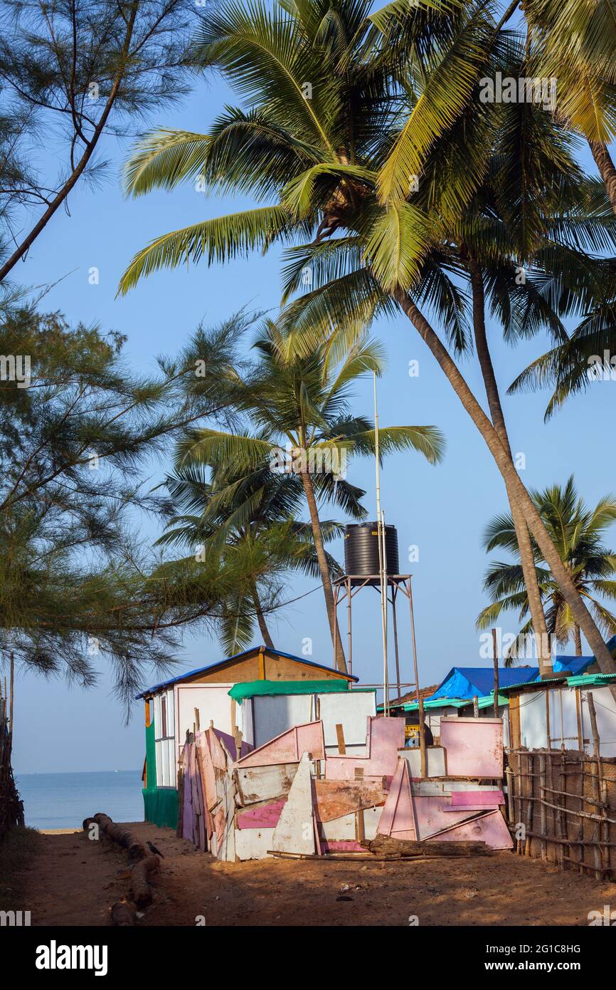 Rear view of charming beach shack that looks over the beach with water ...