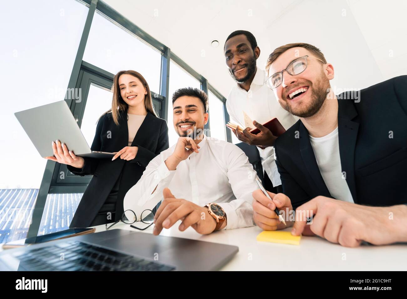 Young multiracial ambitious team of programmers are thinking about a ...