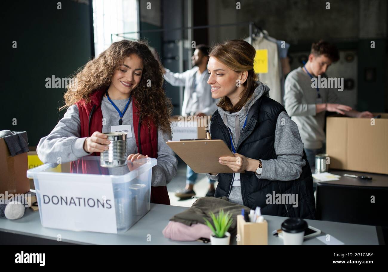 Group of volunteers working in community charity donation center ...