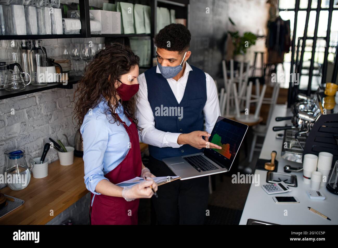 Coffee shop manager discussing issues with waitress in cafe, small ...
