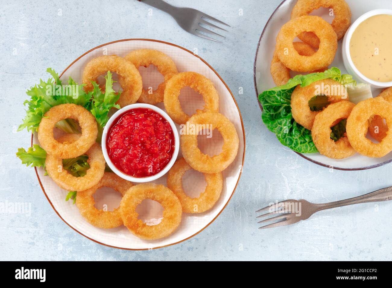 Calamari rings. Squid rings with salad and various dips, overhead shot ...