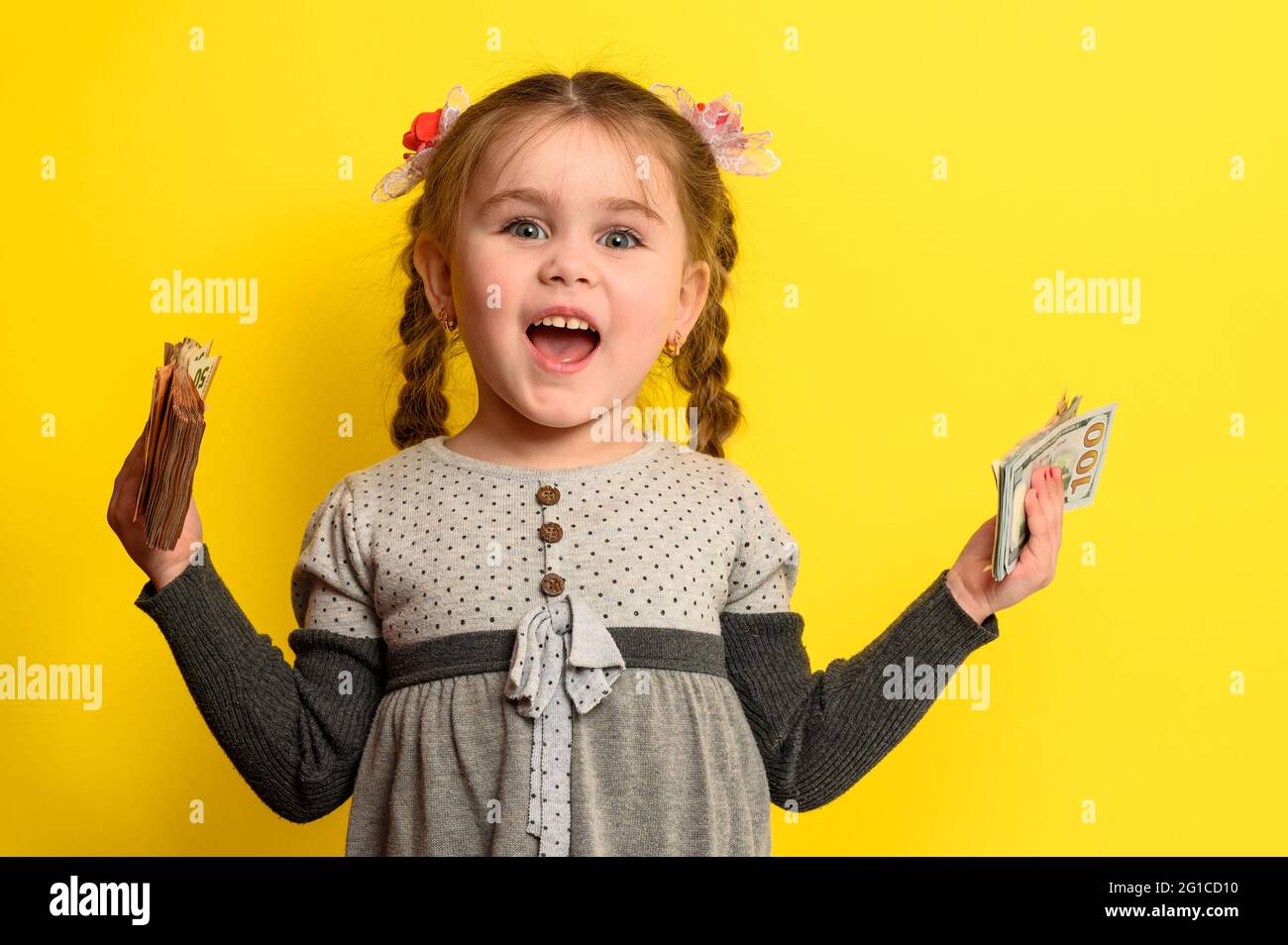 Financial security of the child, the girl holds money in hands, a ...