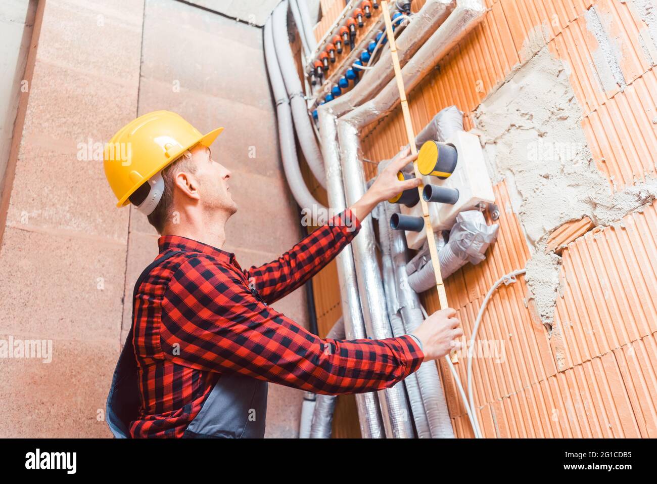 Male engineer installing the pipes Stock Photo - Alamy