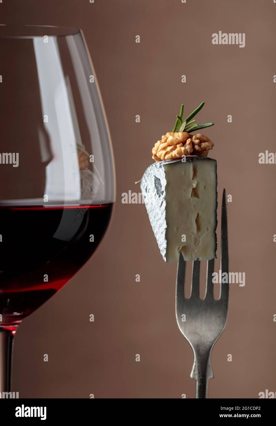 Red wine and soft cheese with walnuts and rosemary Stock Photo - Alamy