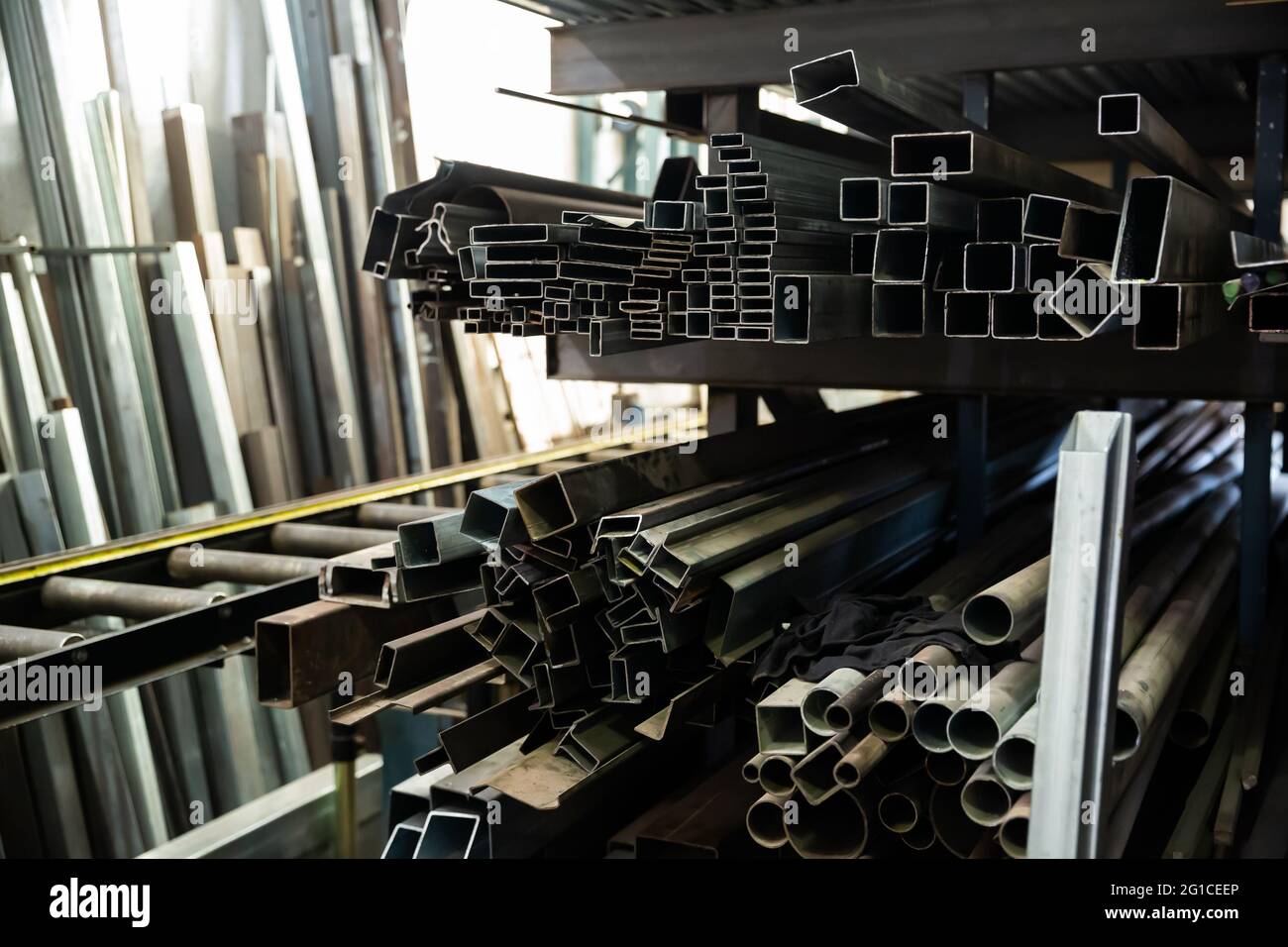Metal profile of the pipe lies on the shelves in the workshop Stock ...