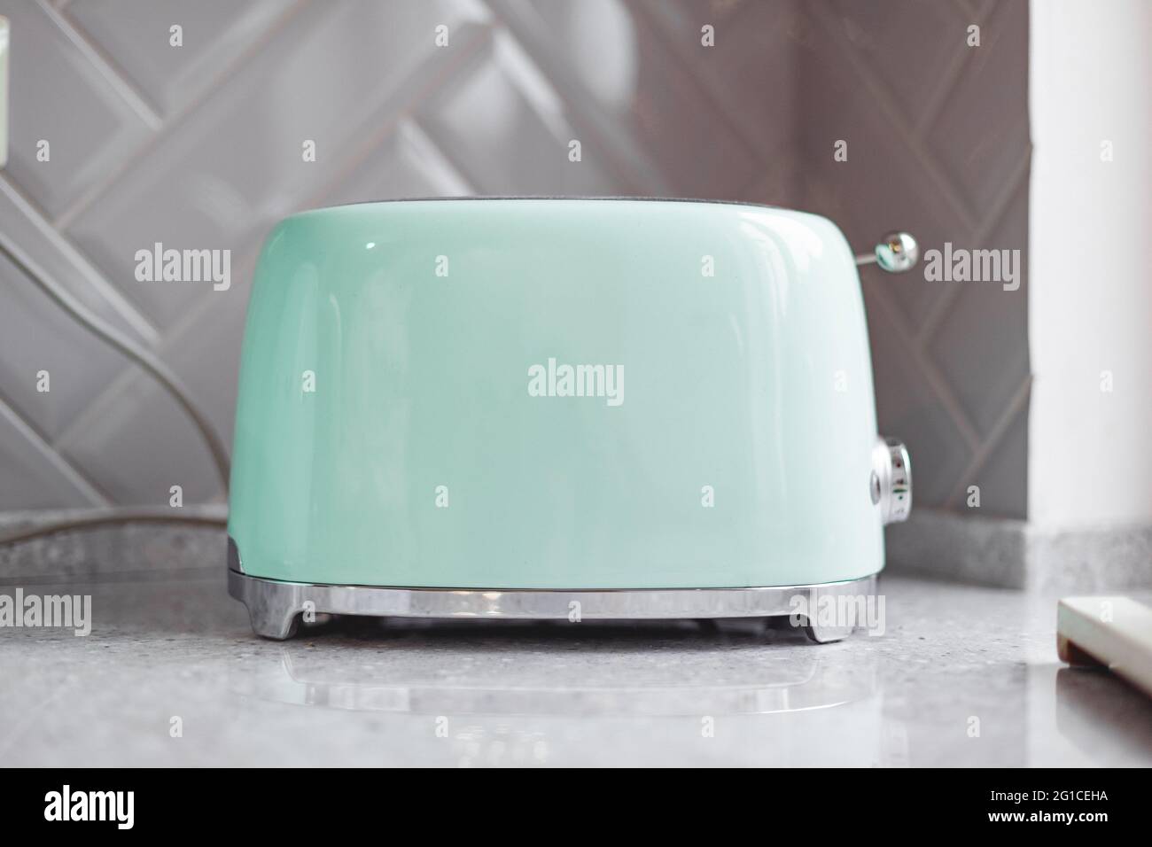 Green toaster on gray stone kitchen countertop Stock Photo - Alamy