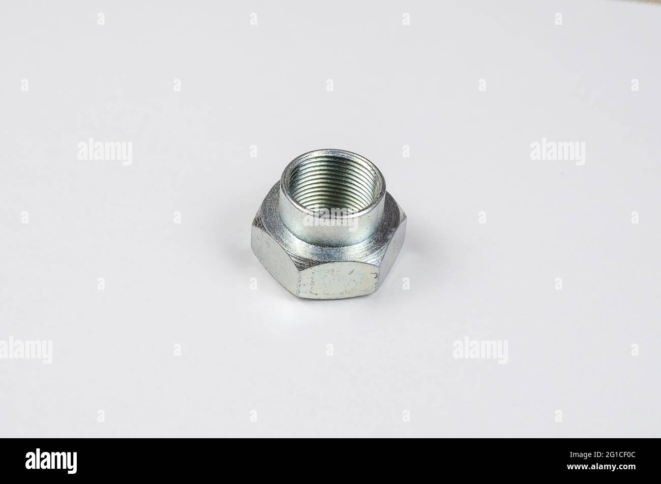 Hub nut on white background. New Silver front car hub nut. Auto parts ...