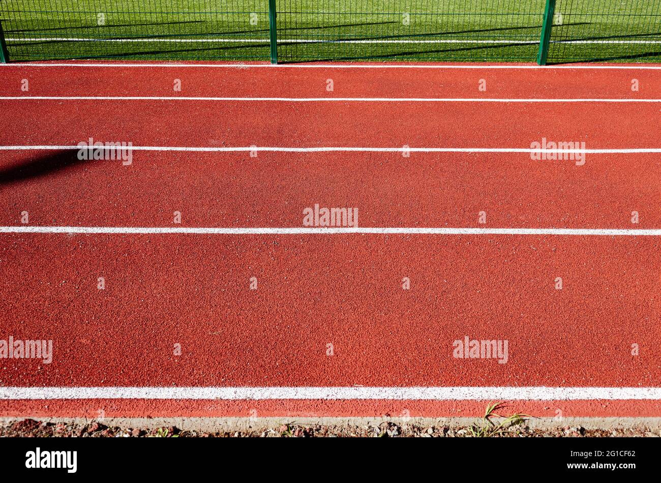 Red treadmill on sport field. Running track on the stadium Stock Photo ...
