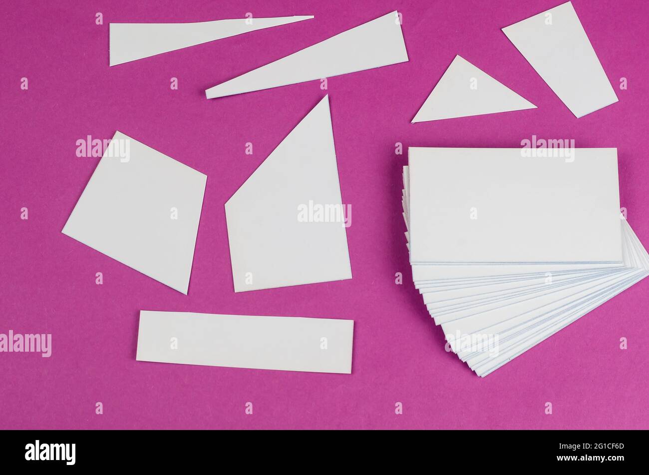 Random white geometric shapes on pink. Trapezoids, rectangle, triangle ...