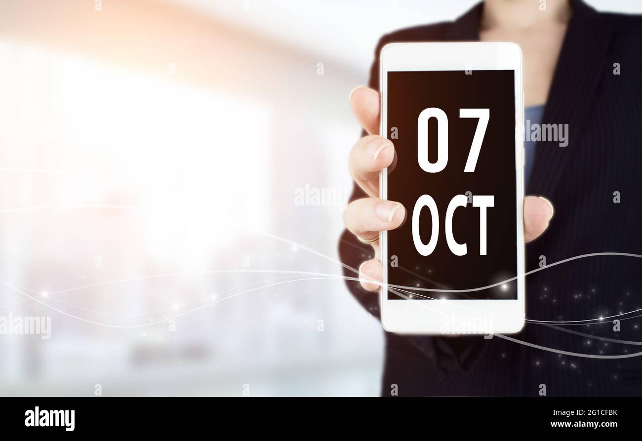 October 7th. Day 7 of month, Calendar date. White smartphone with ...