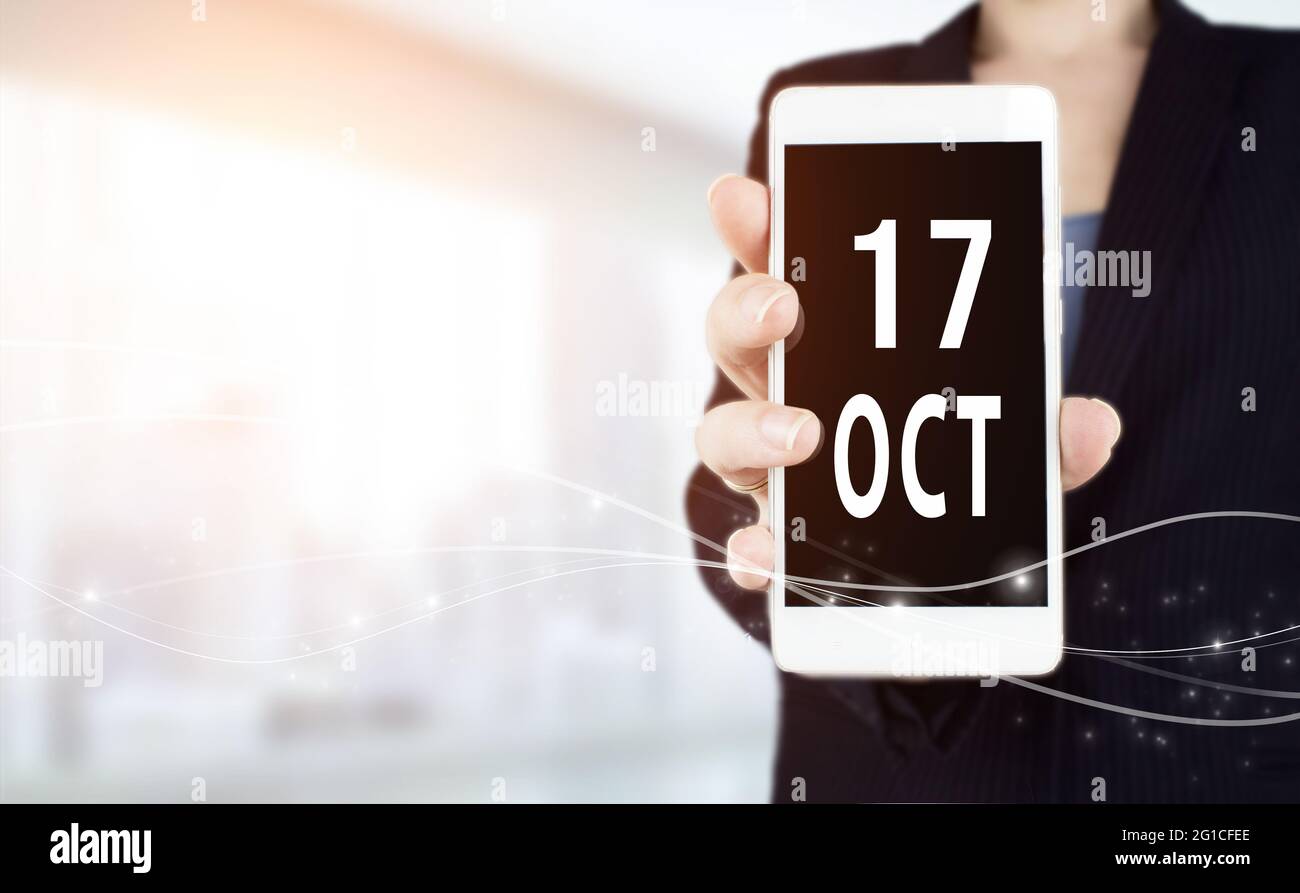 October 17th. Day 17 of month, Calendar date. White smartphone with ...