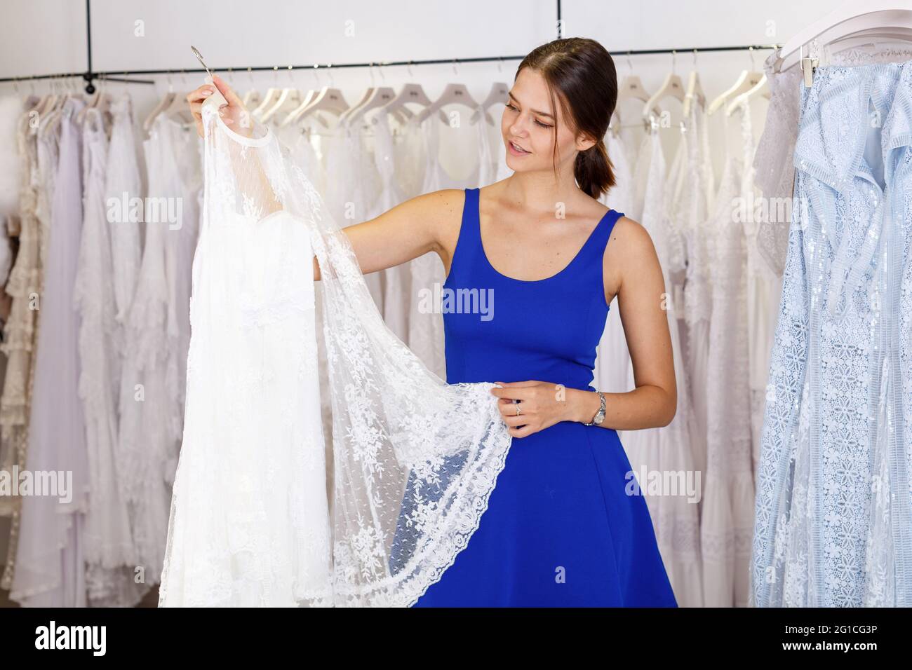 Girl choosing wedding dress Stock Photo - Alamy