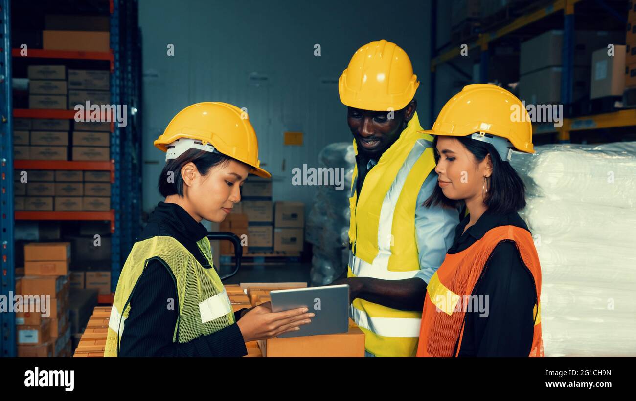 Warehouse worker working together in the storehouse . Logistics ...