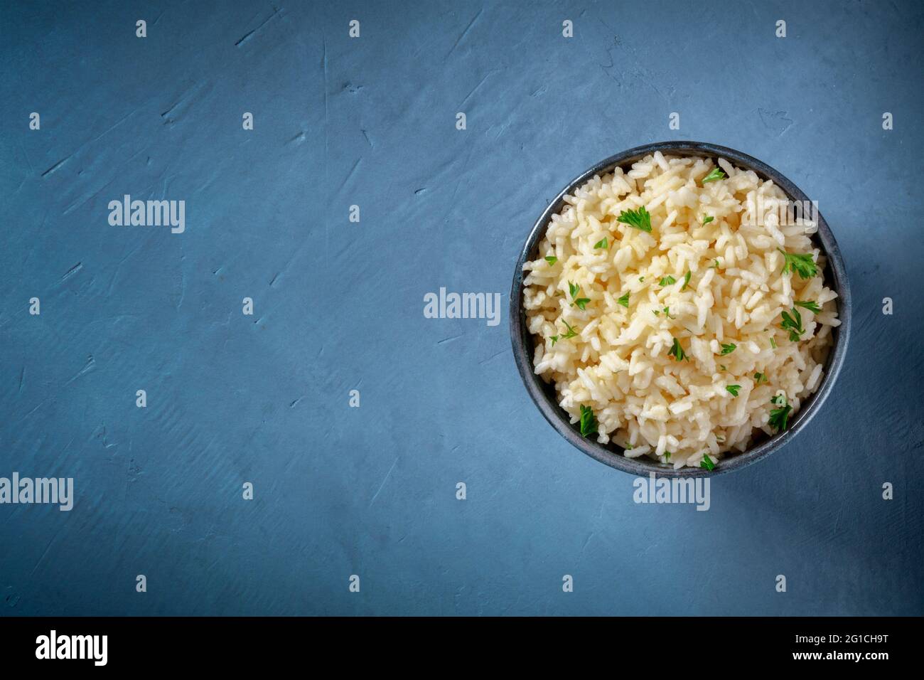 Rice, shot from above on a dark blue background with a place for text ...