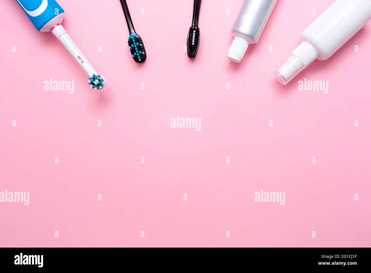 An electric toothbrush and plastic toothbrushes, with toothpaste and ...