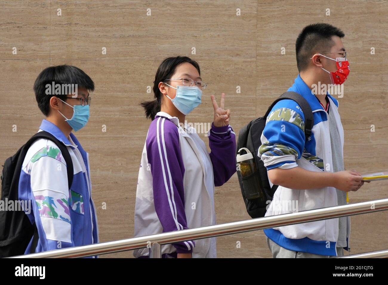 Beijing, China. 7th June, 2021. Examinees queue up to enter a high ...