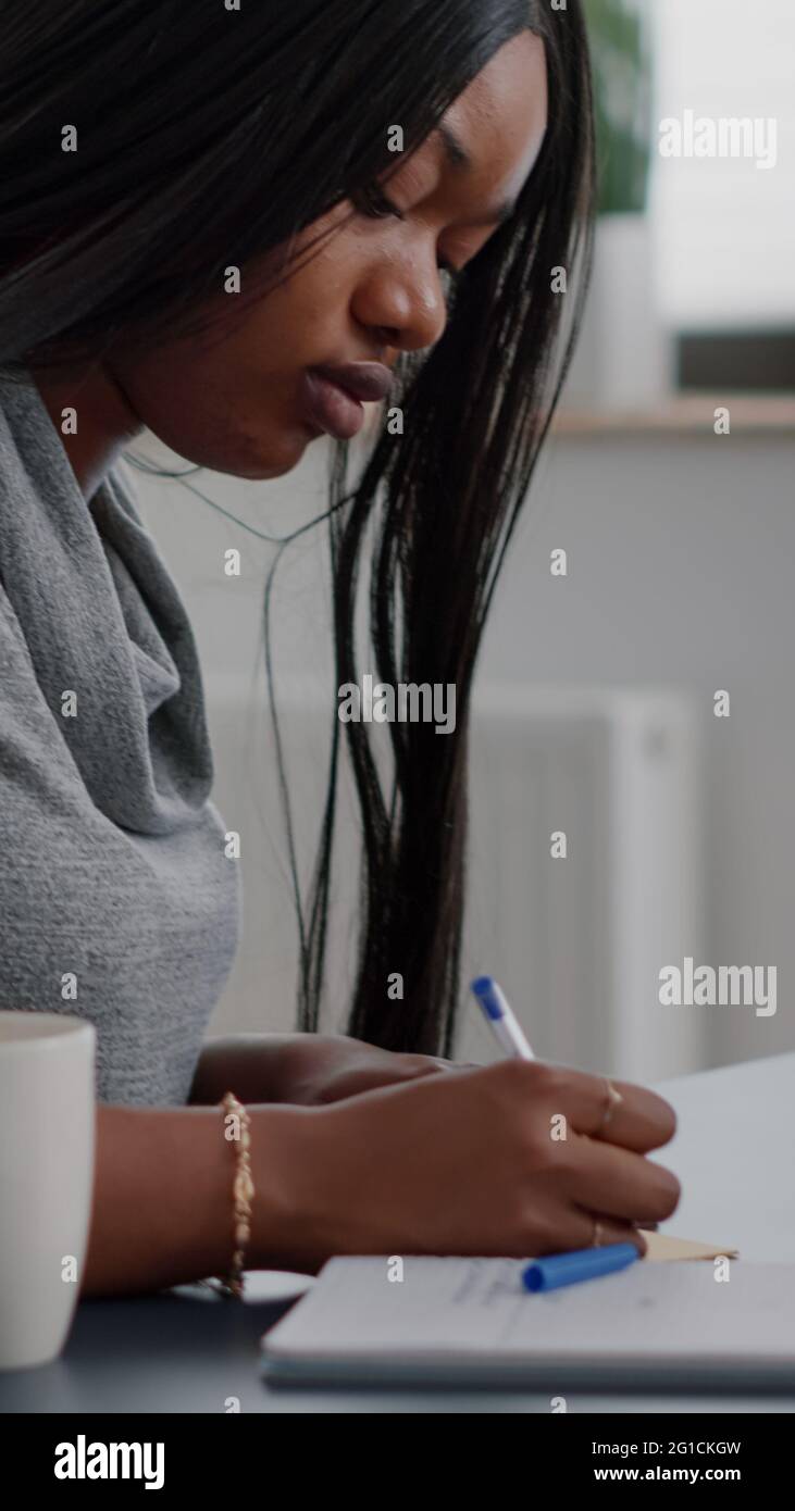 African american student writing univeristy information on stickey ...