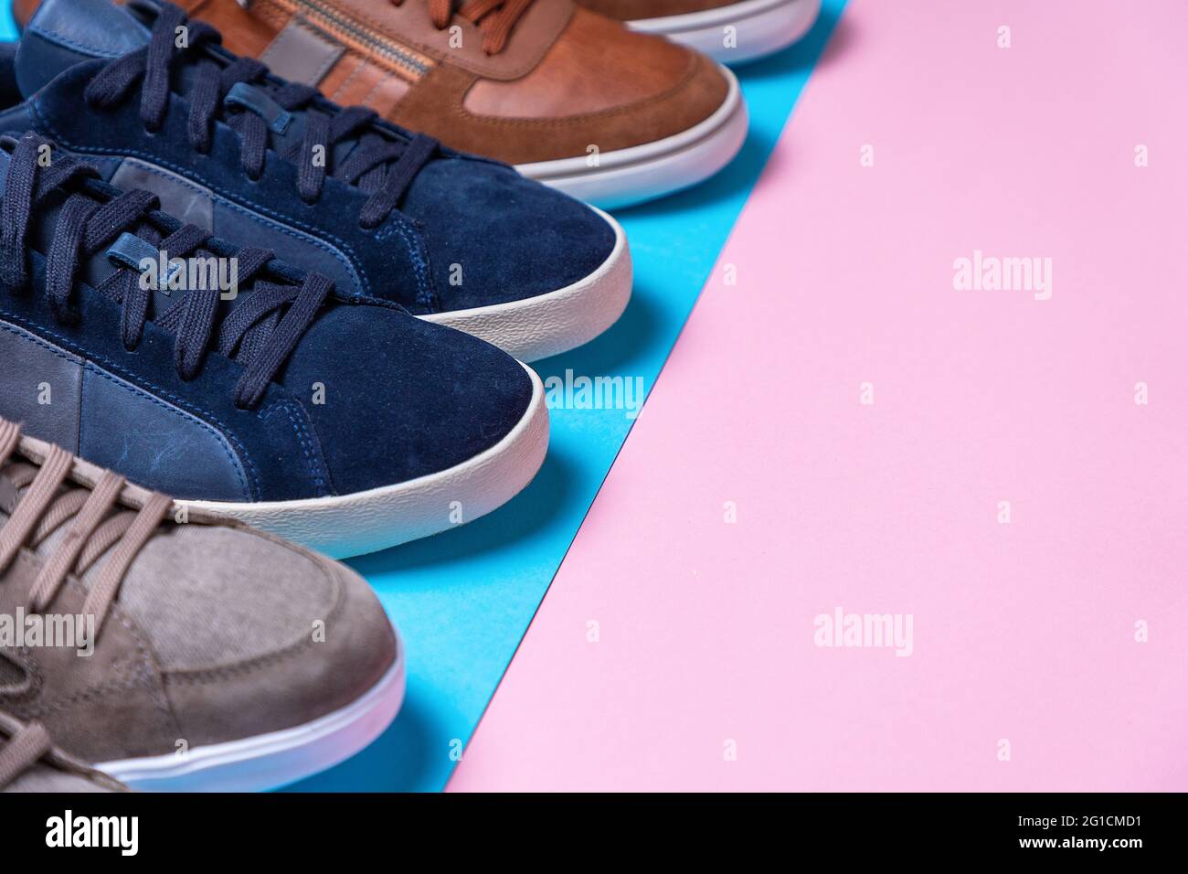 New male's multi-colored sneakers stacked in a row. Shoe tips close-up ...