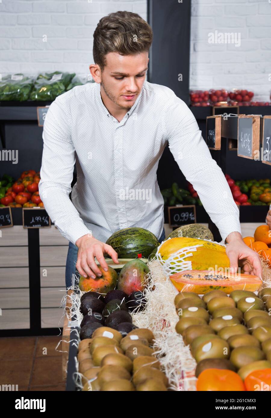 Man choosing fruits in grocery shop Stock Photo - Alamy