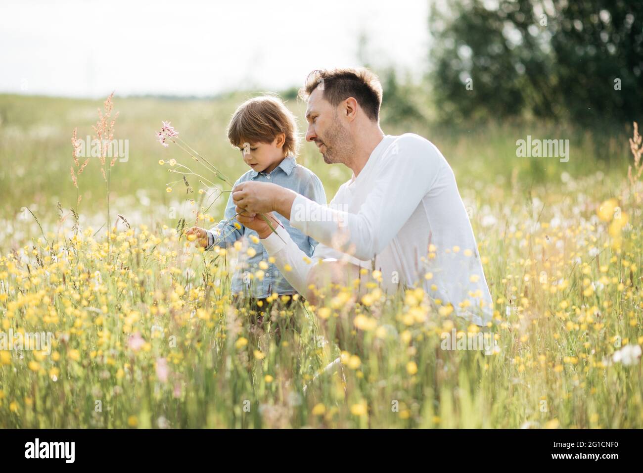 Modern fatherhood photo concept, young dad spends time with little son ...