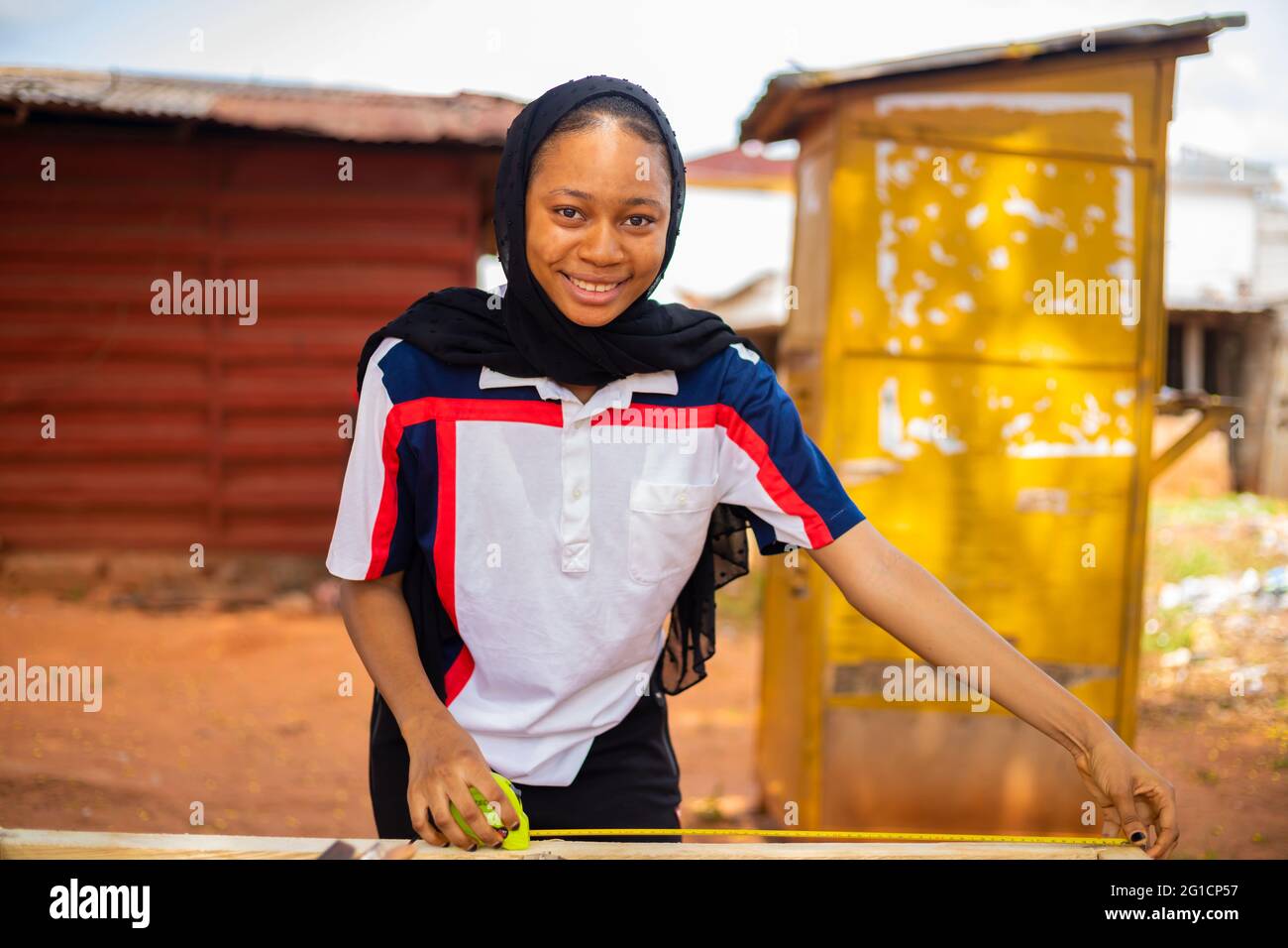 beautiful african professional carpenter smiling as she takes ...