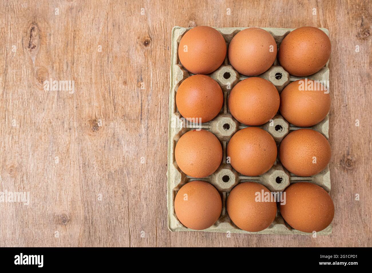 Overhead shot of a dozen of red eggs in a carton cell box Stock Photo ...