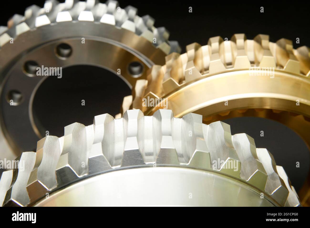 Steel and copper gears on a black background Stock Photo - Alamy