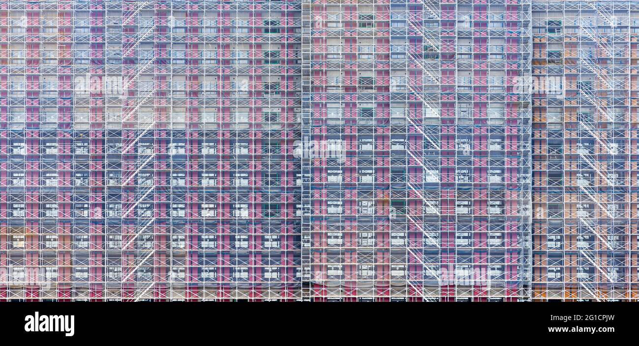 Side view of big building under construction with many floors and rooms ...