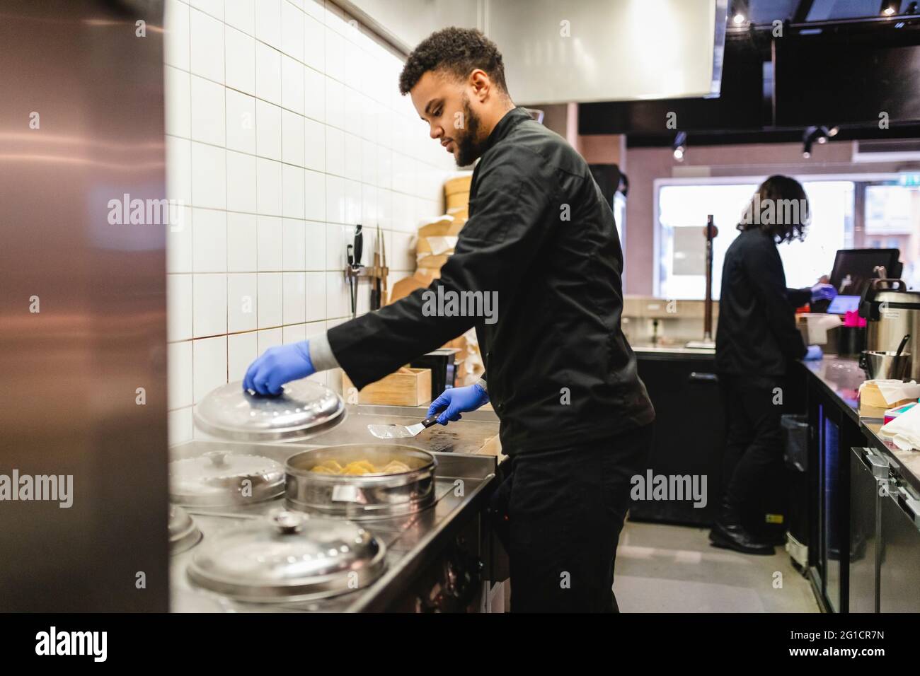 Male chef preparing dumplings in kitchen at restaurant Stock Photo - Alamy