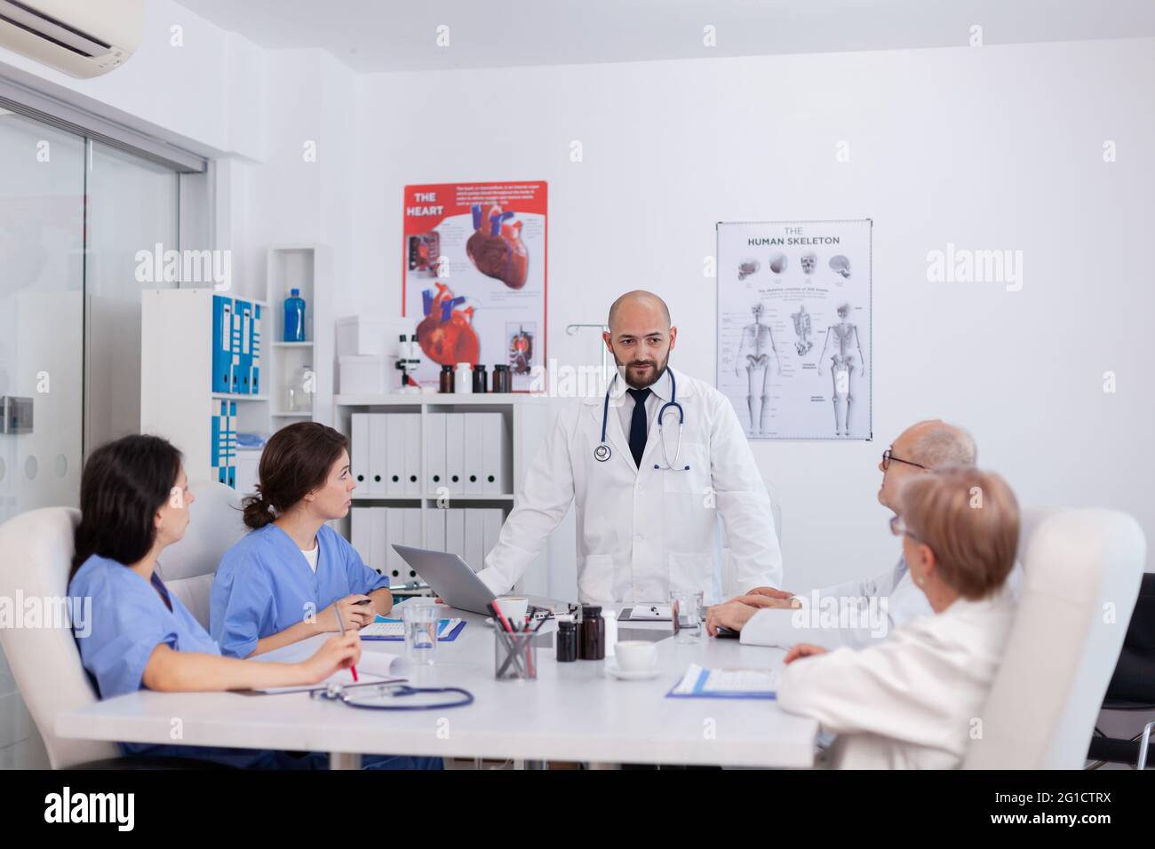 Medical team having meeting in hospital conference room planning ...