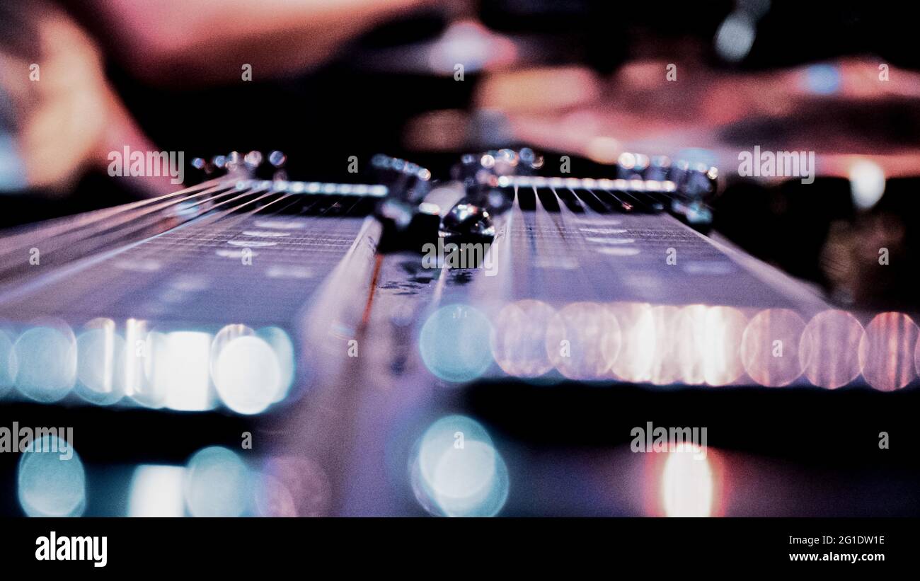 Selective focus of the strings on a pedal steel guitar against a ...