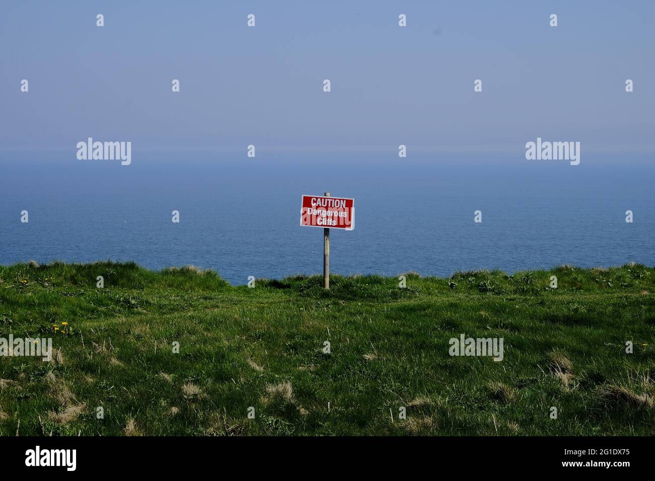 Cliff danger sign Stock Photo - Alamy