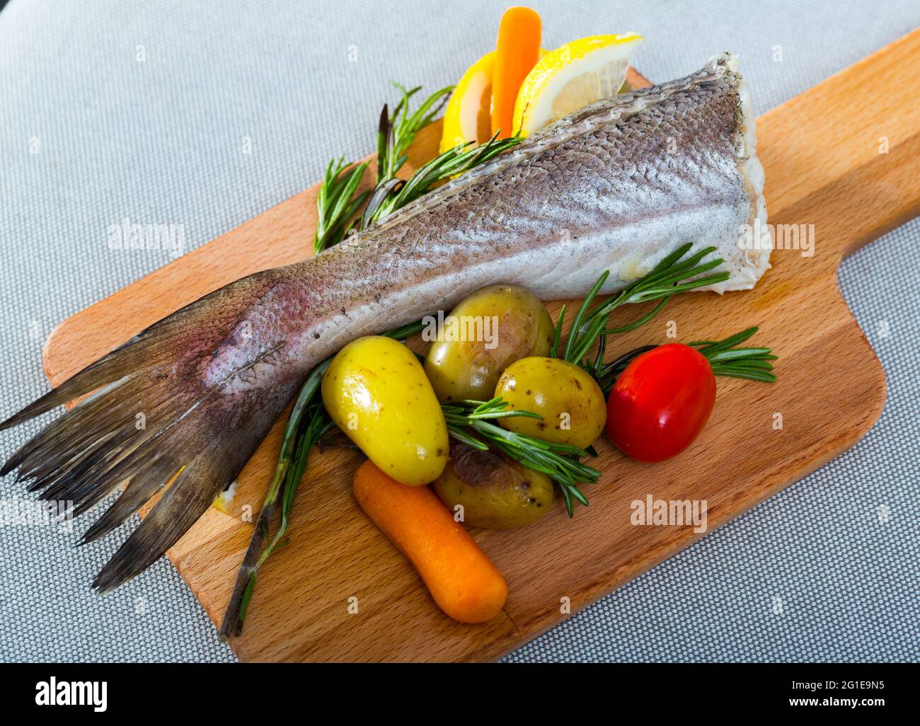 Country style baked merluccius Stock Photo - Alamy