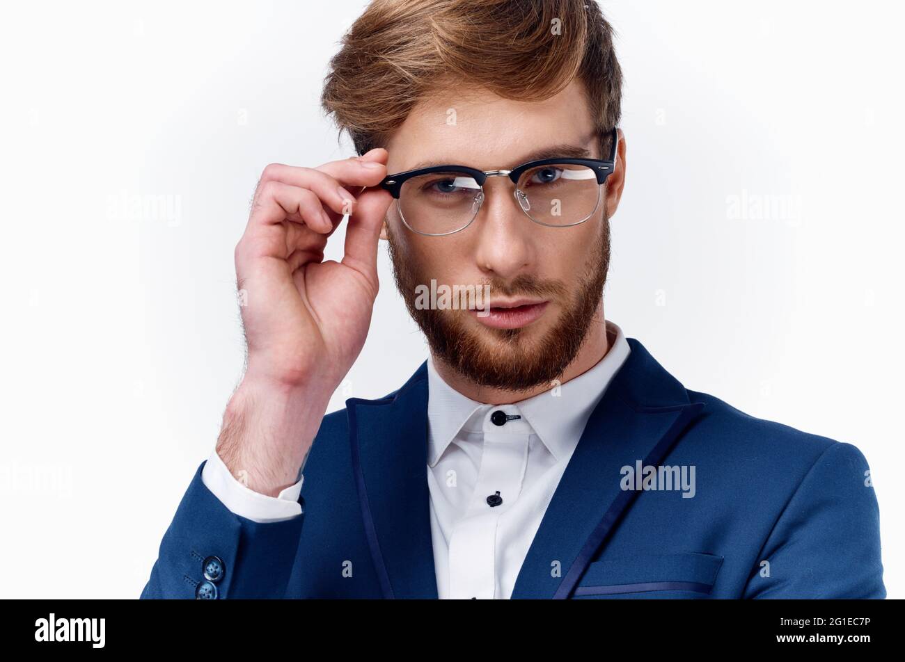 business man in a jacket and shirt straightens glasses on his face ...